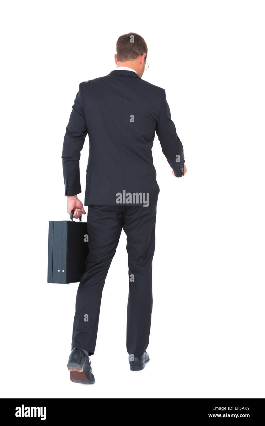 Businessman walking with his briefcase Stock Photo - Alamy