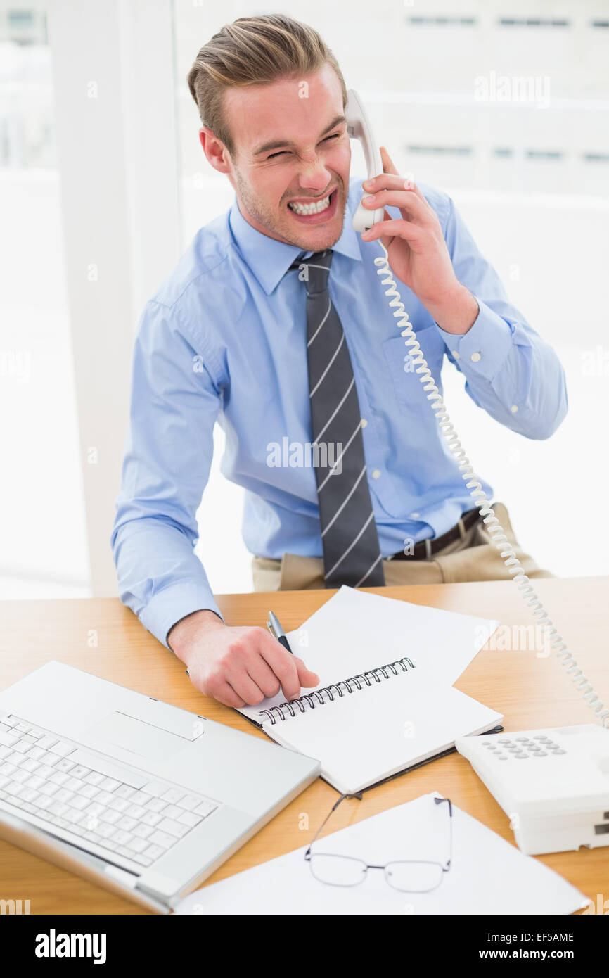 Frustrated businessman on the phone Stock Photo - Alamy