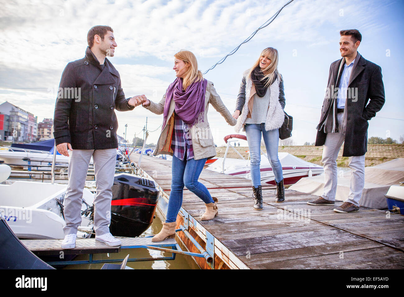 Four friends holding hands hi-res stock photography and images - Alamy