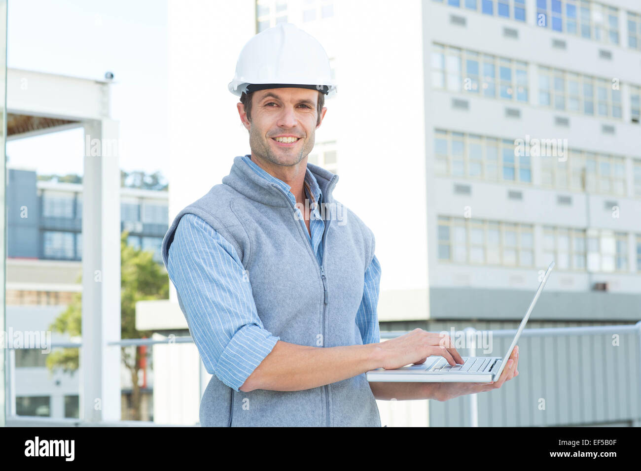 Confident male architect using laptop Stock Photo - Alamy