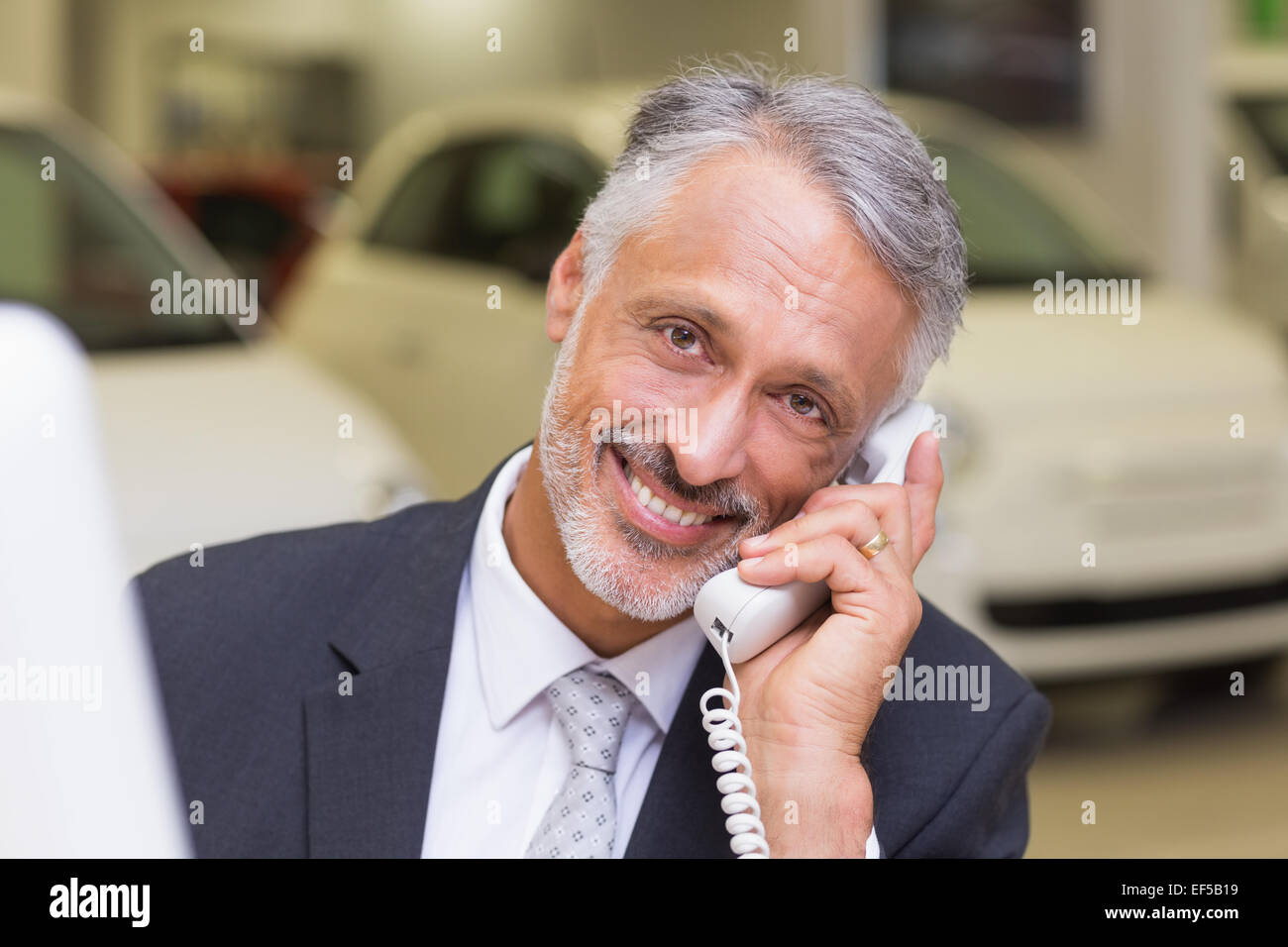 Smiling businessman making a phone call Stock Photo - Alamy