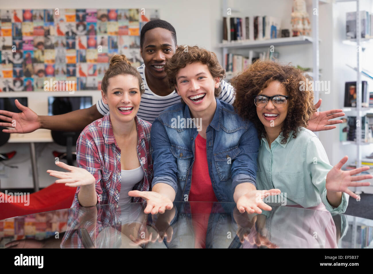 Fashion students smiling at camera together Stock Photo - Alamy