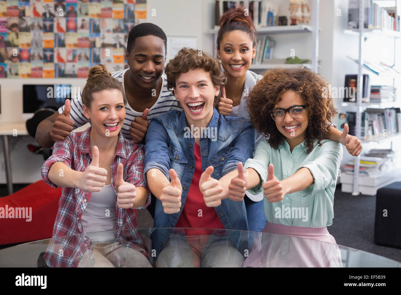 Fashion students smiling at camera together Stock Photo - Alamy