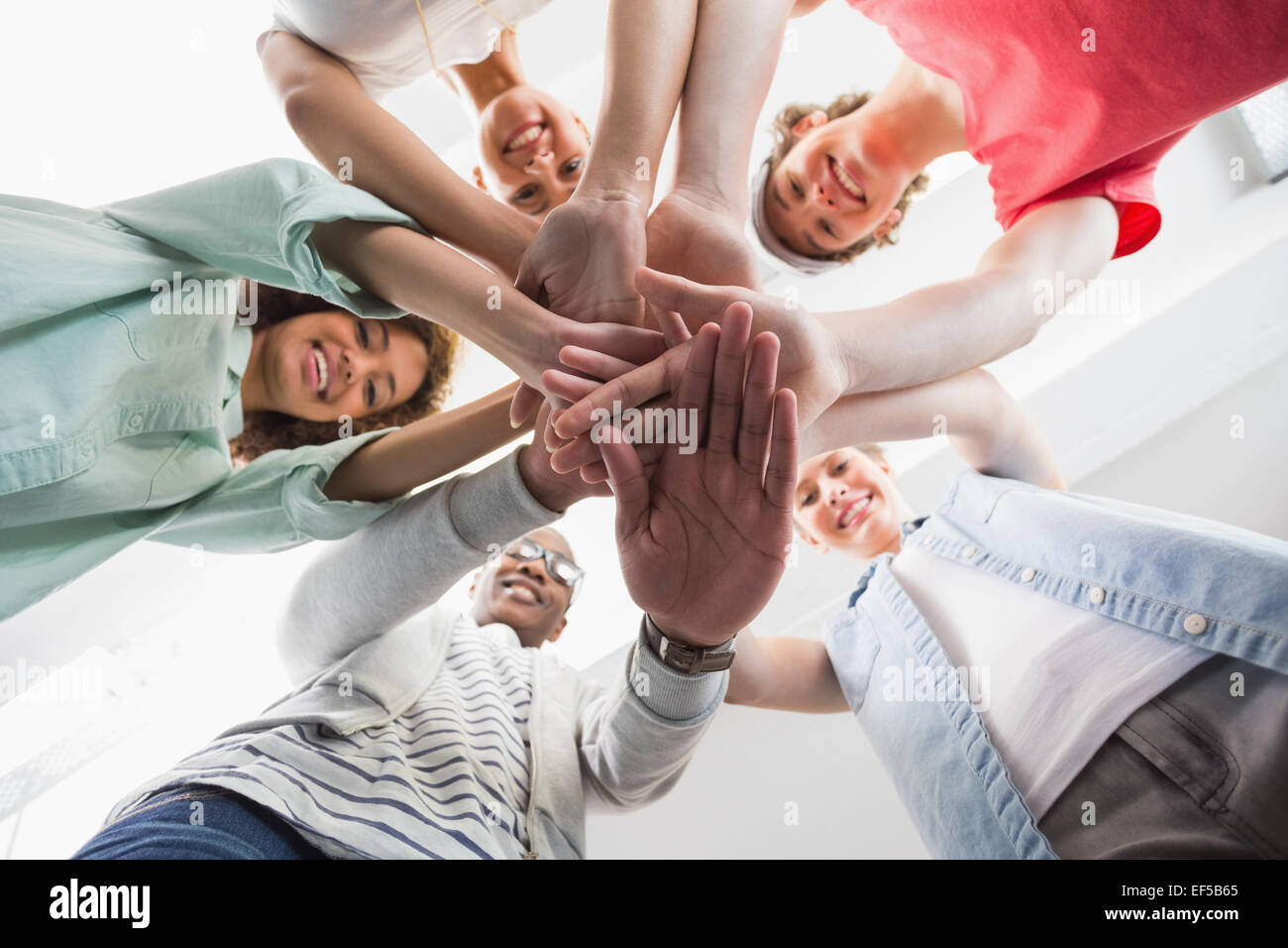 Fashion students putting hands together Stock Photo - Alamy