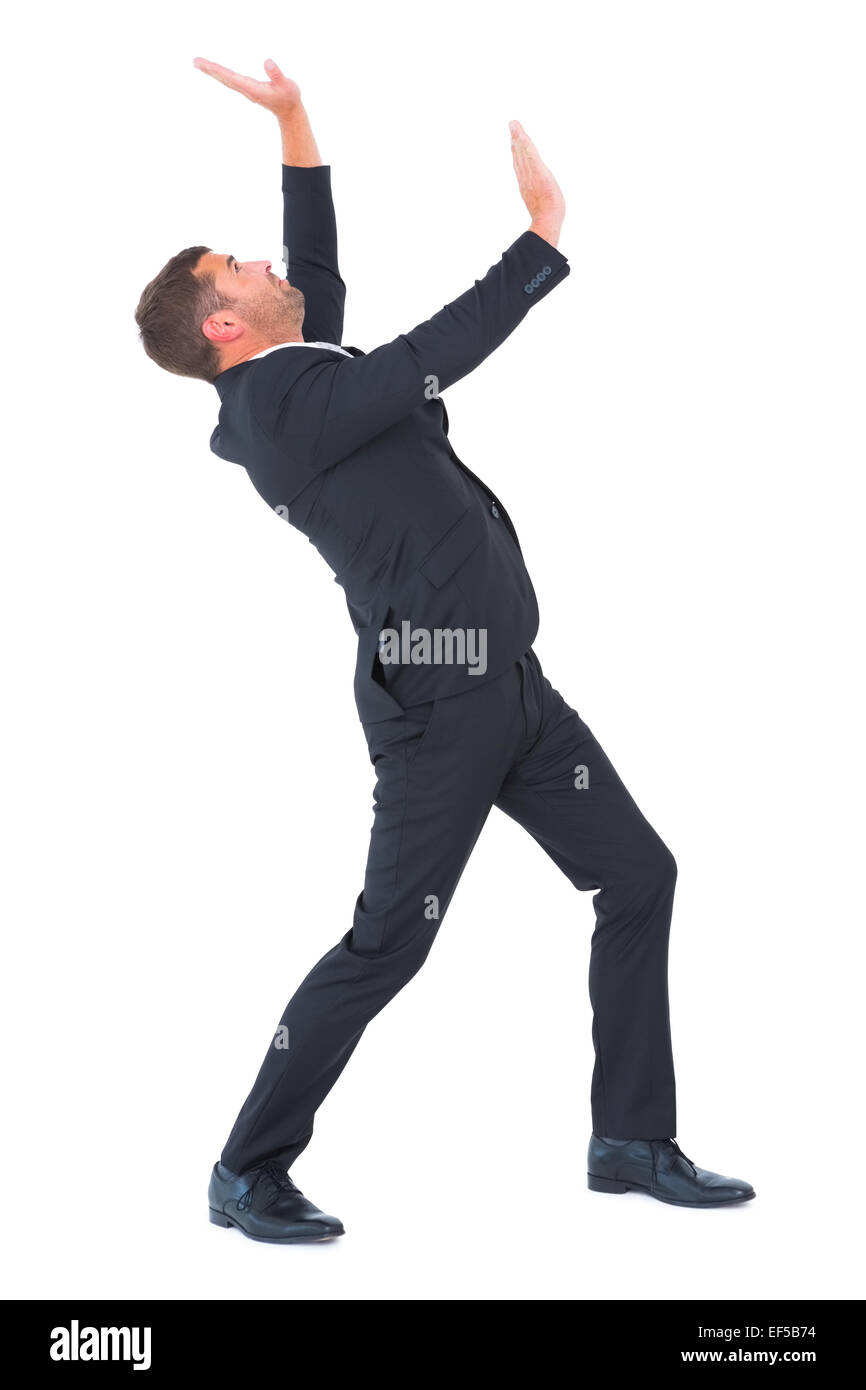 Businessman bending and pushing Stock Photo - Alamy