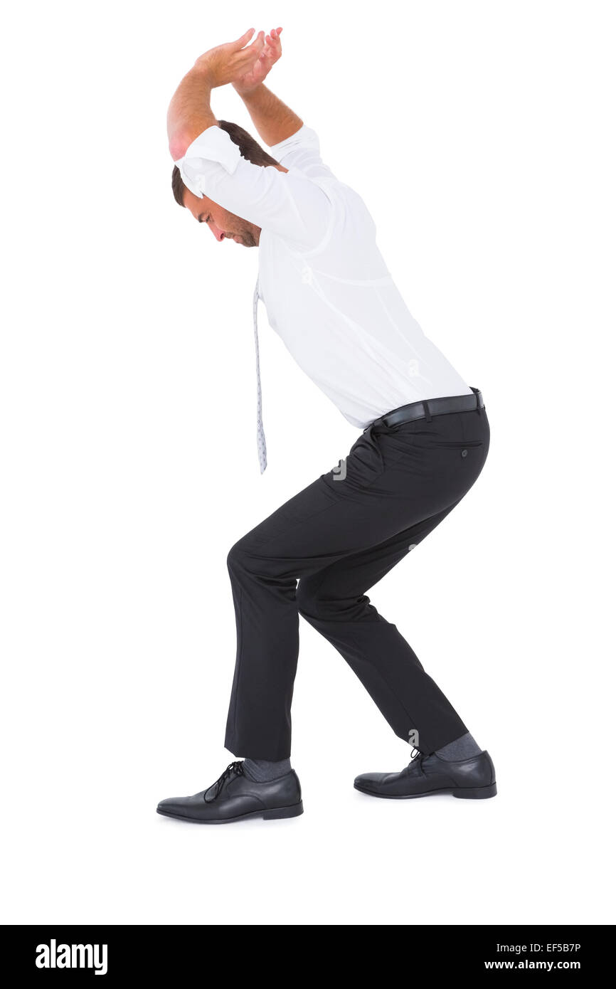 Businessman bending and pushing Stock Photo - Alamy