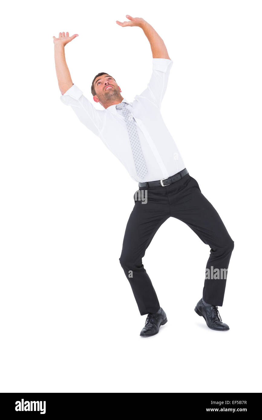 Businessman bending and pushing Stock Photo - Alamy