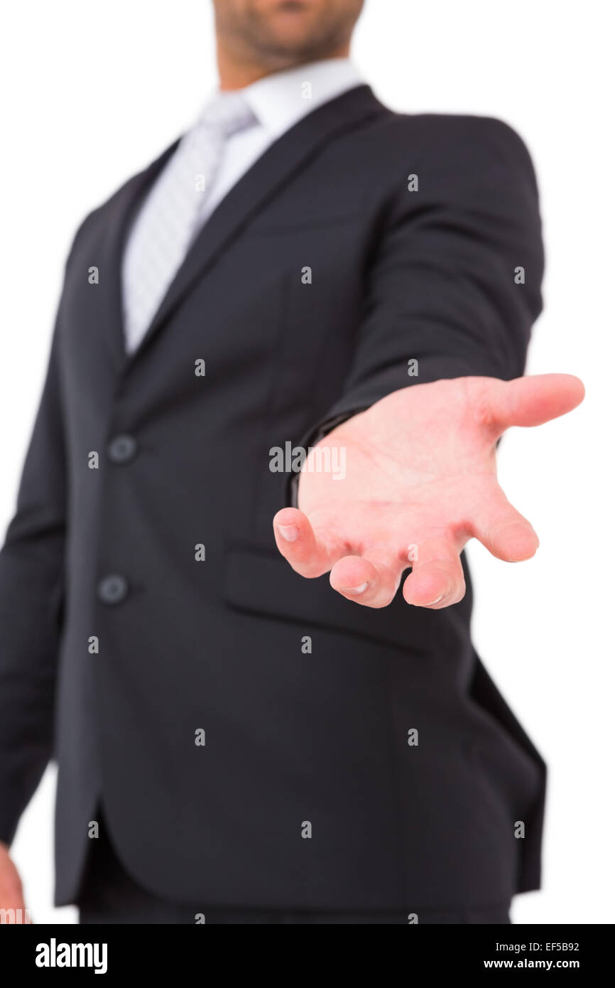 Businessman holding out his hand Stock Photo - Alamy
