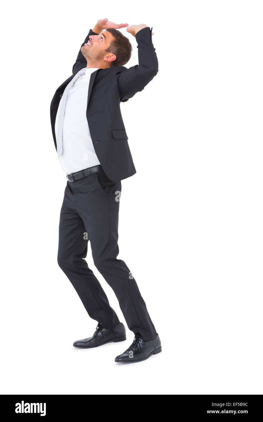 Businessman bending and pushing Stock Photo - Alamy
