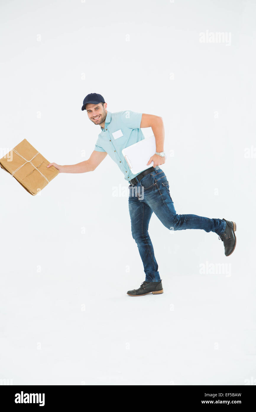 Happy delivery man running with package Stock Photo - Alamy
