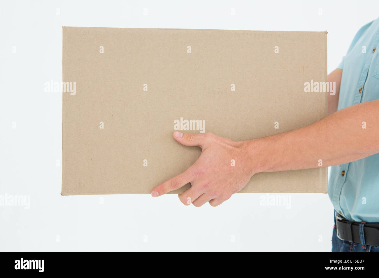 Delivery man carrying cardboard box Stock Photo - Alamy
