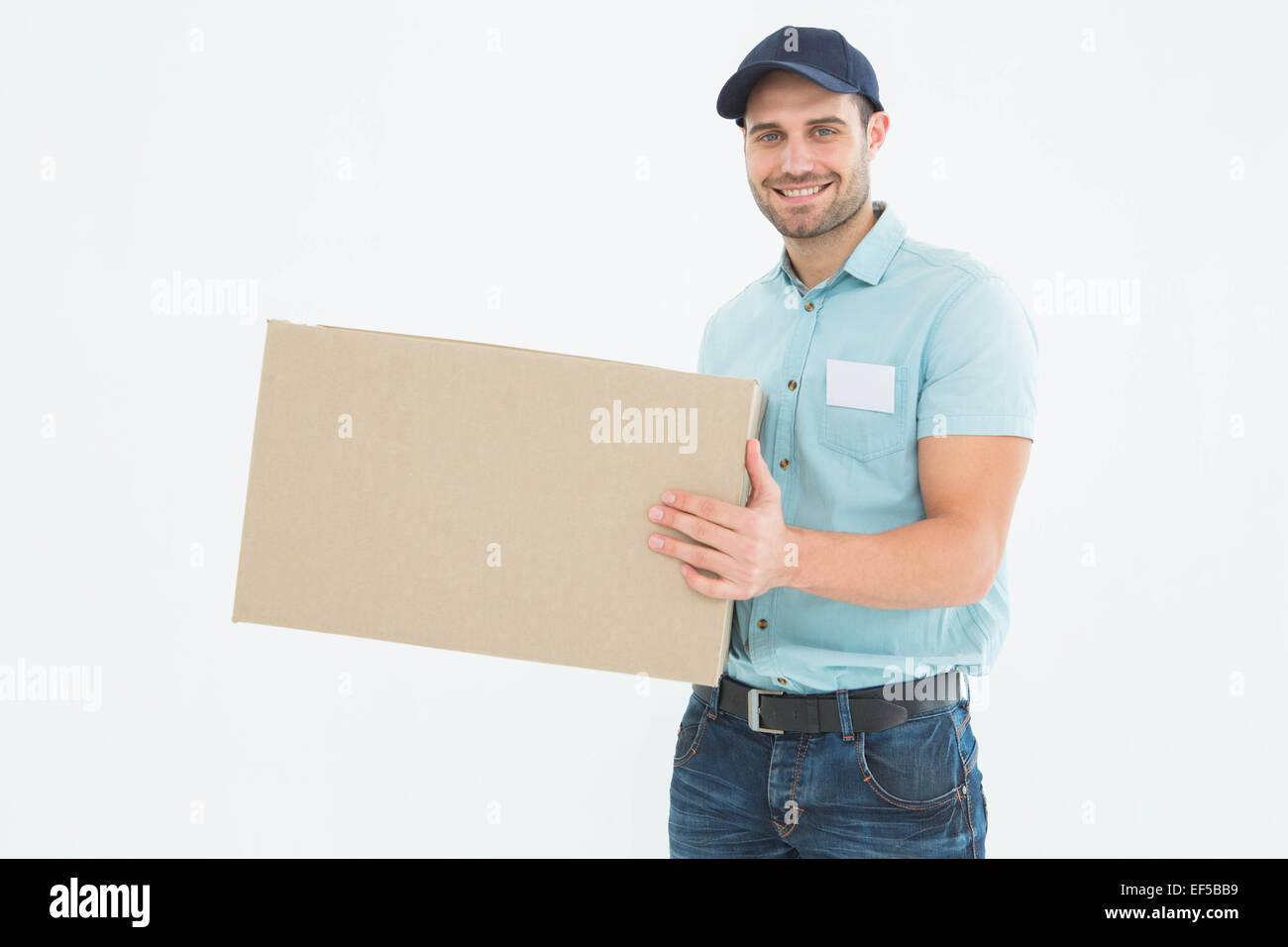 Courier man carrying cardboard box Stock Photo - Alamy