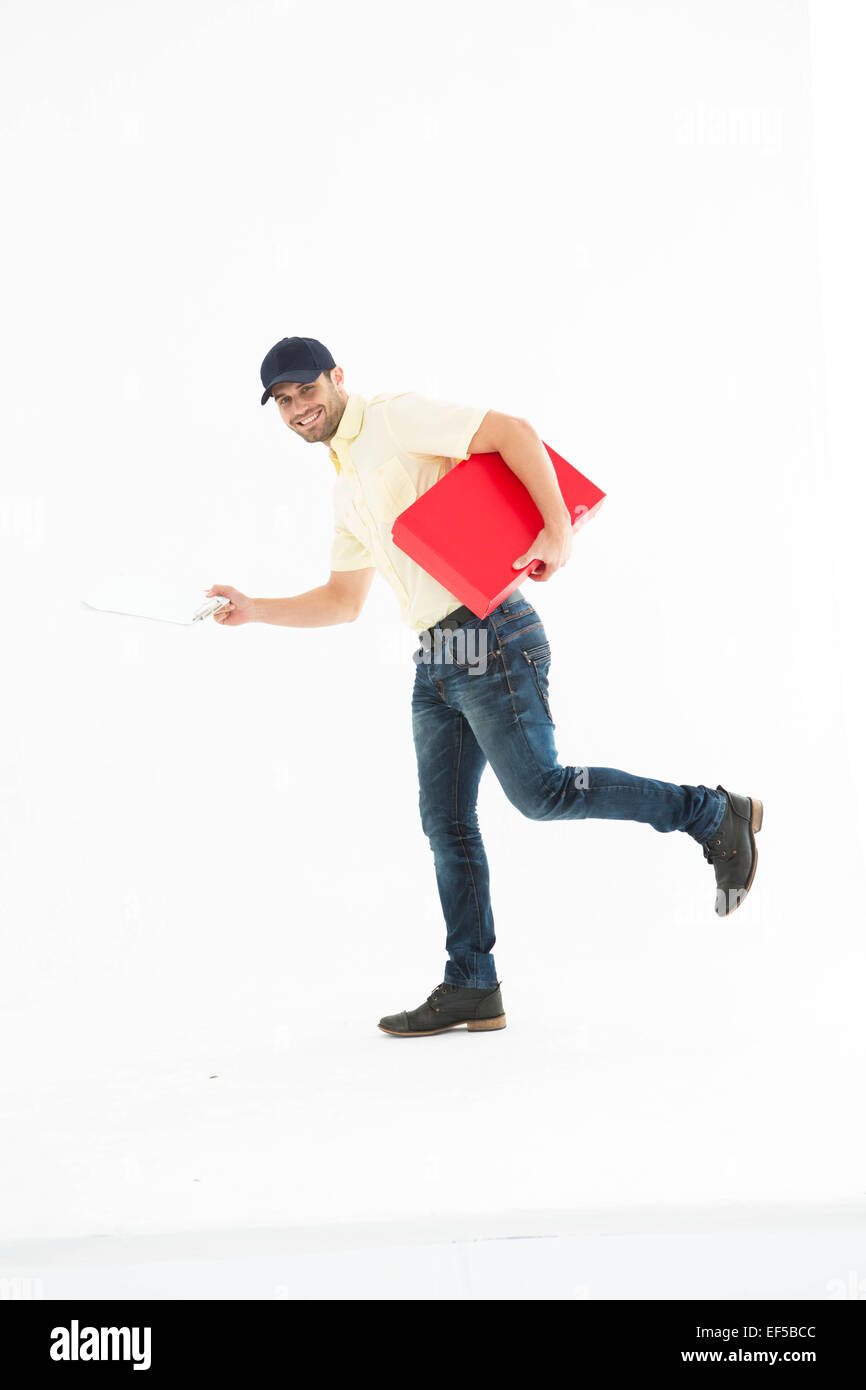 Delivery man with red box running on white background Stock Photo - Alamy