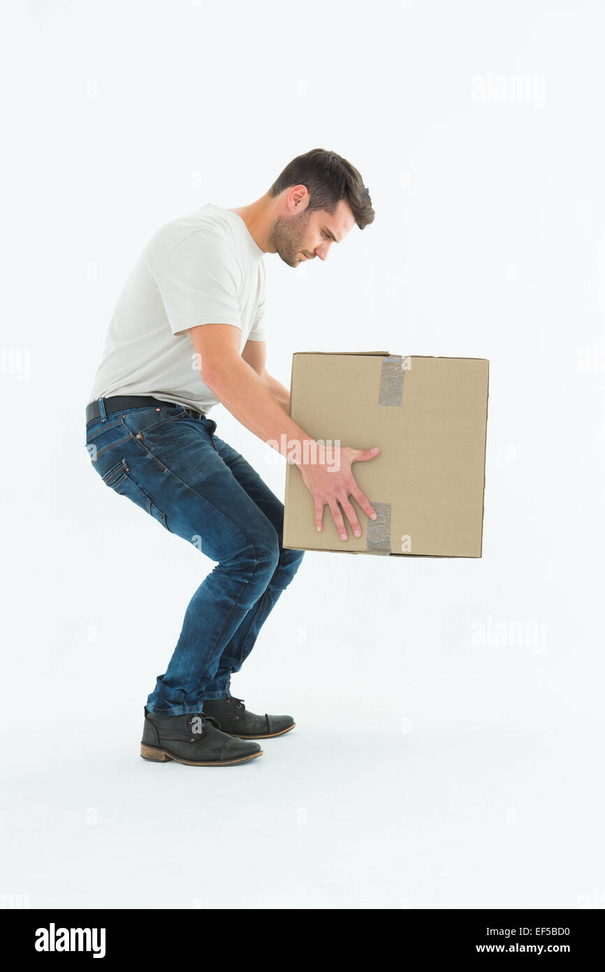 Courier man picking up cardboard box Stock Photo - Alamy