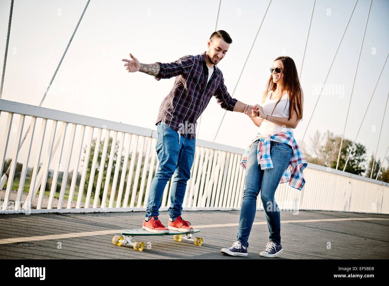 Woman balancing on skateboard man hi-res stock photography and images ...