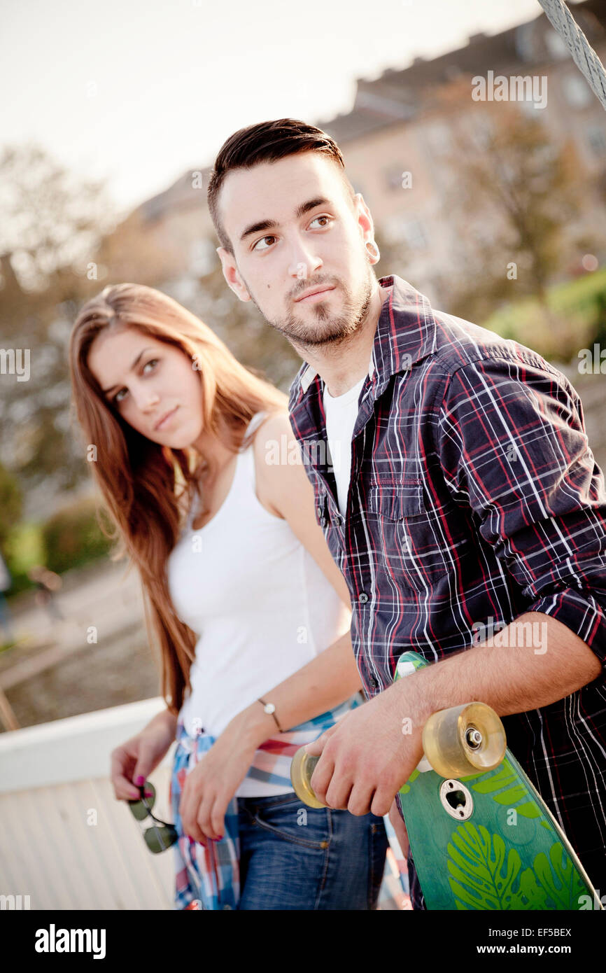 Portrait of young couple with skateboard Stock Photo - Alamy