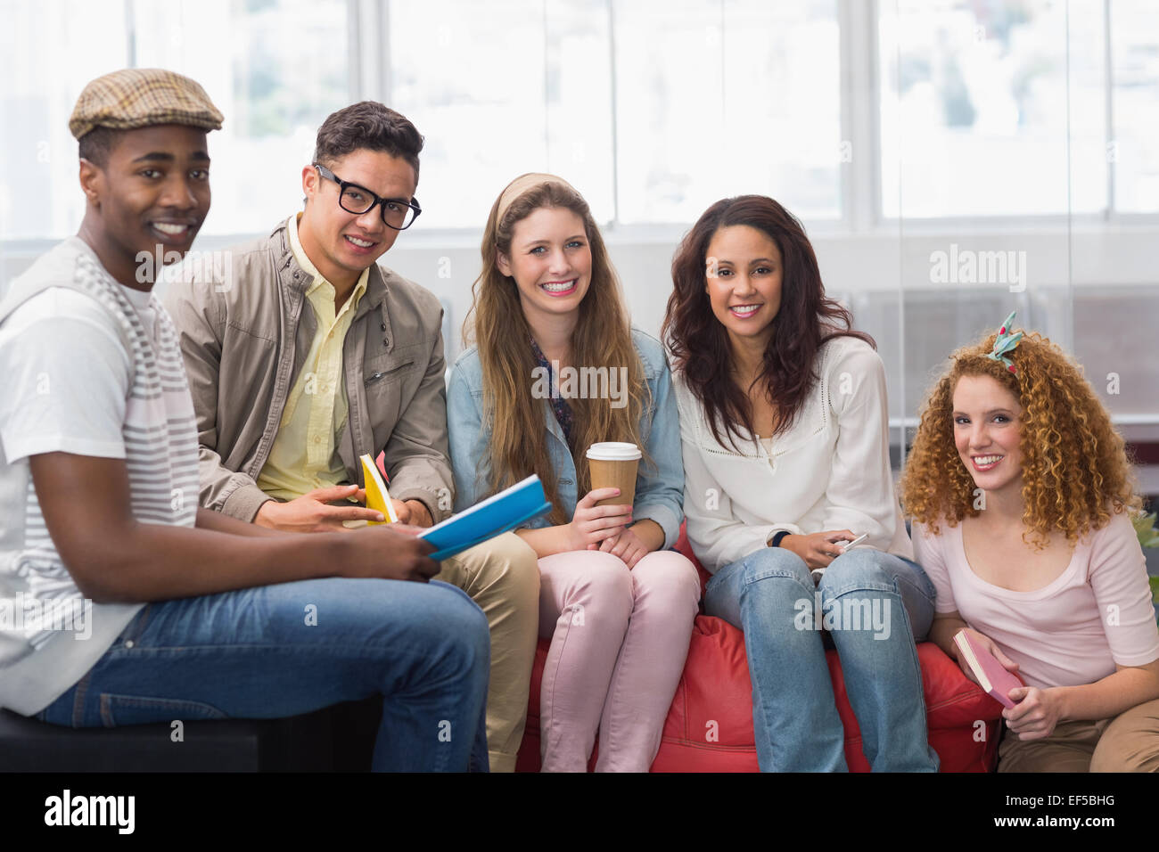Fashion students smiling at camera together Stock Photo - Alamy
