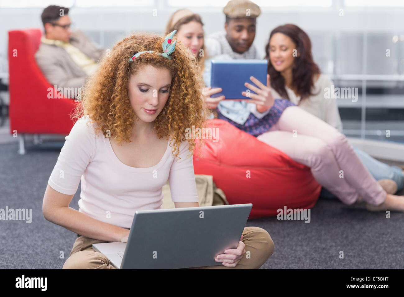 Fashion student using her laptop Stock Photo - Alamy