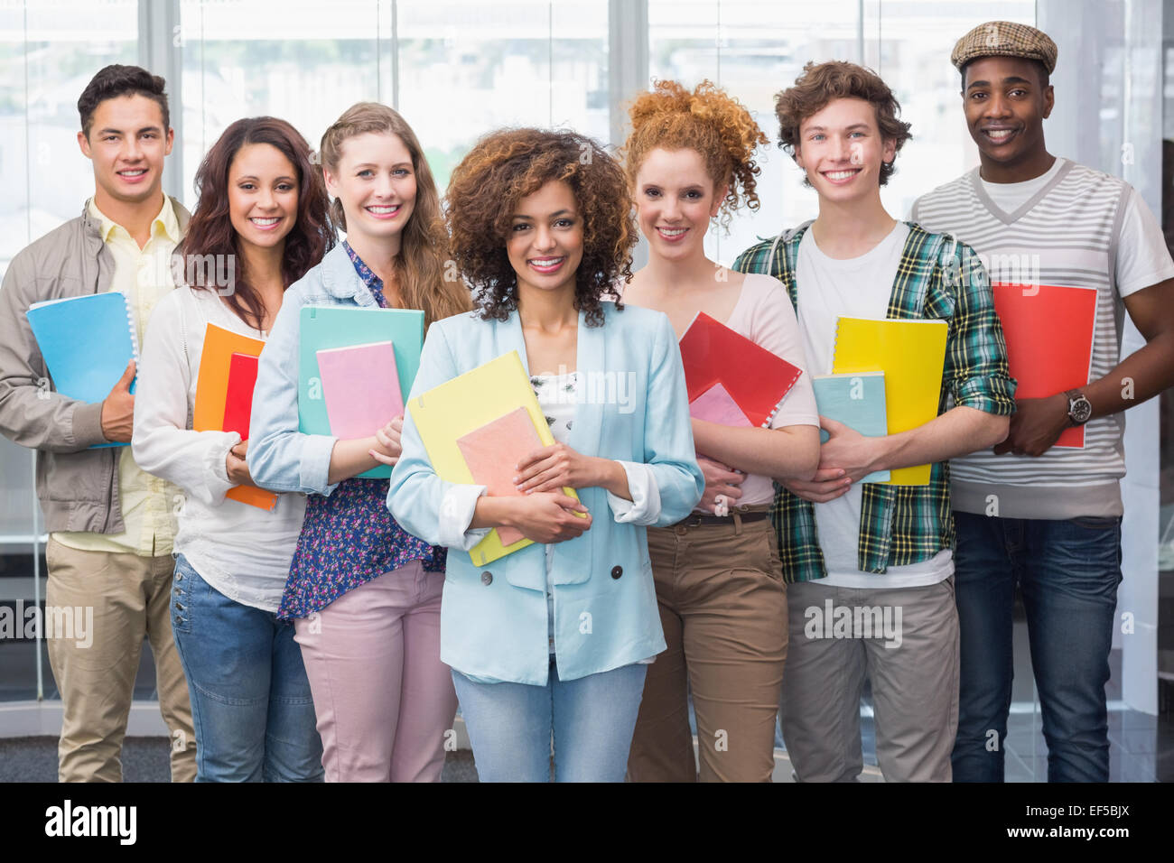 Fashion students smiling at camera together Stock Photo - Alamy