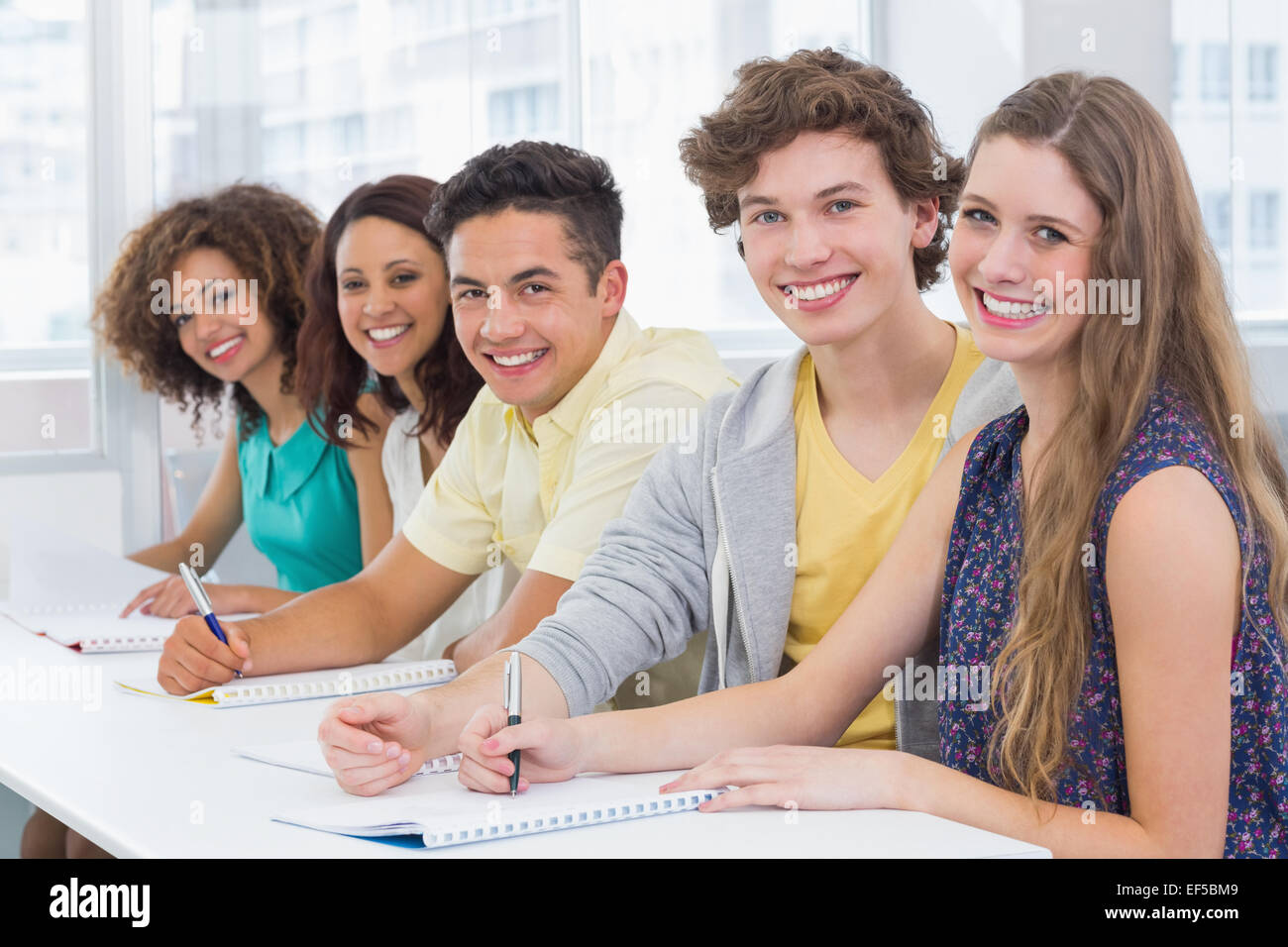 Fashion students taking notes in class Stock Photo - Alamy