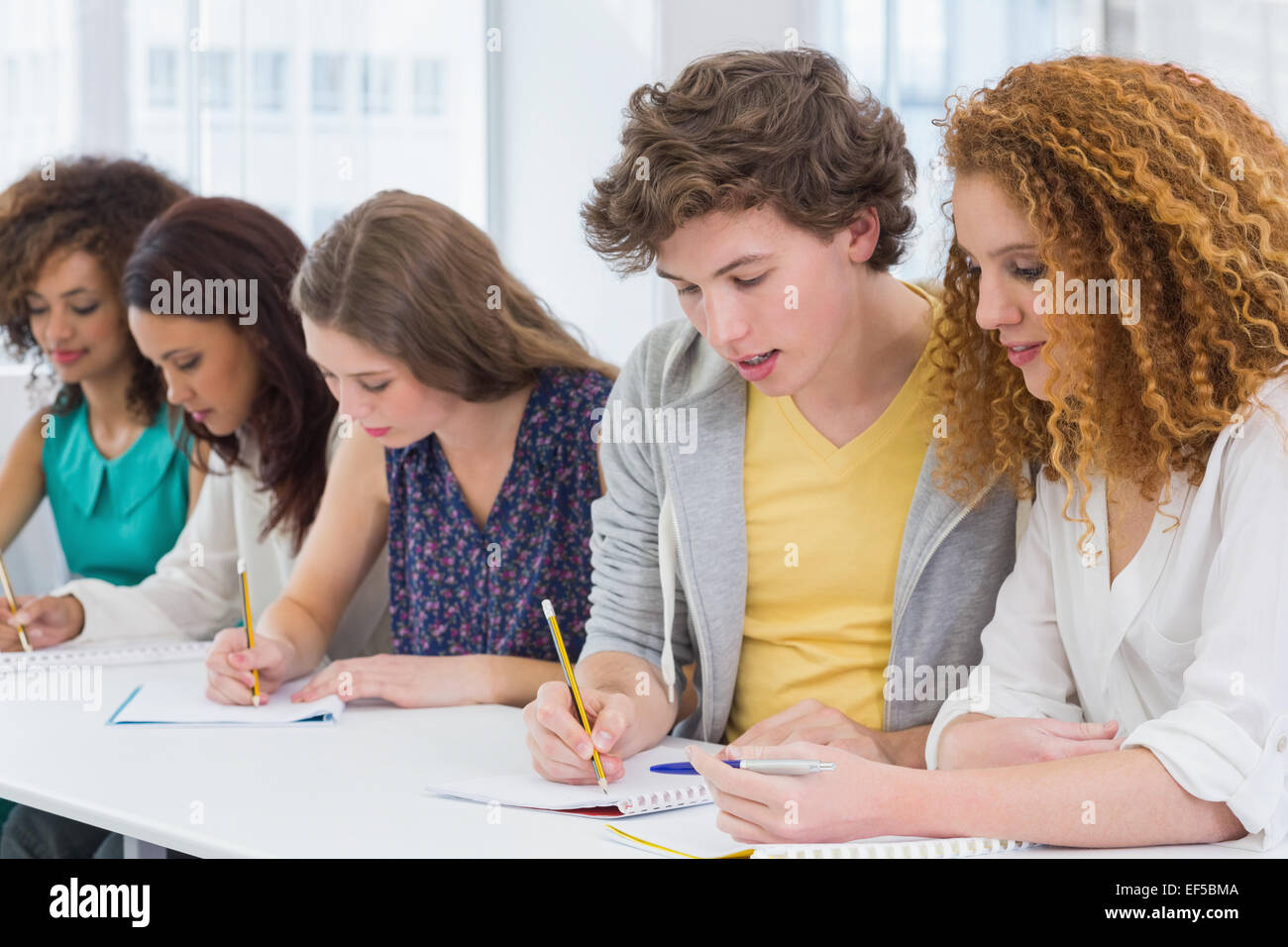 Fashion students taking notes in class Stock Photo - Alamy