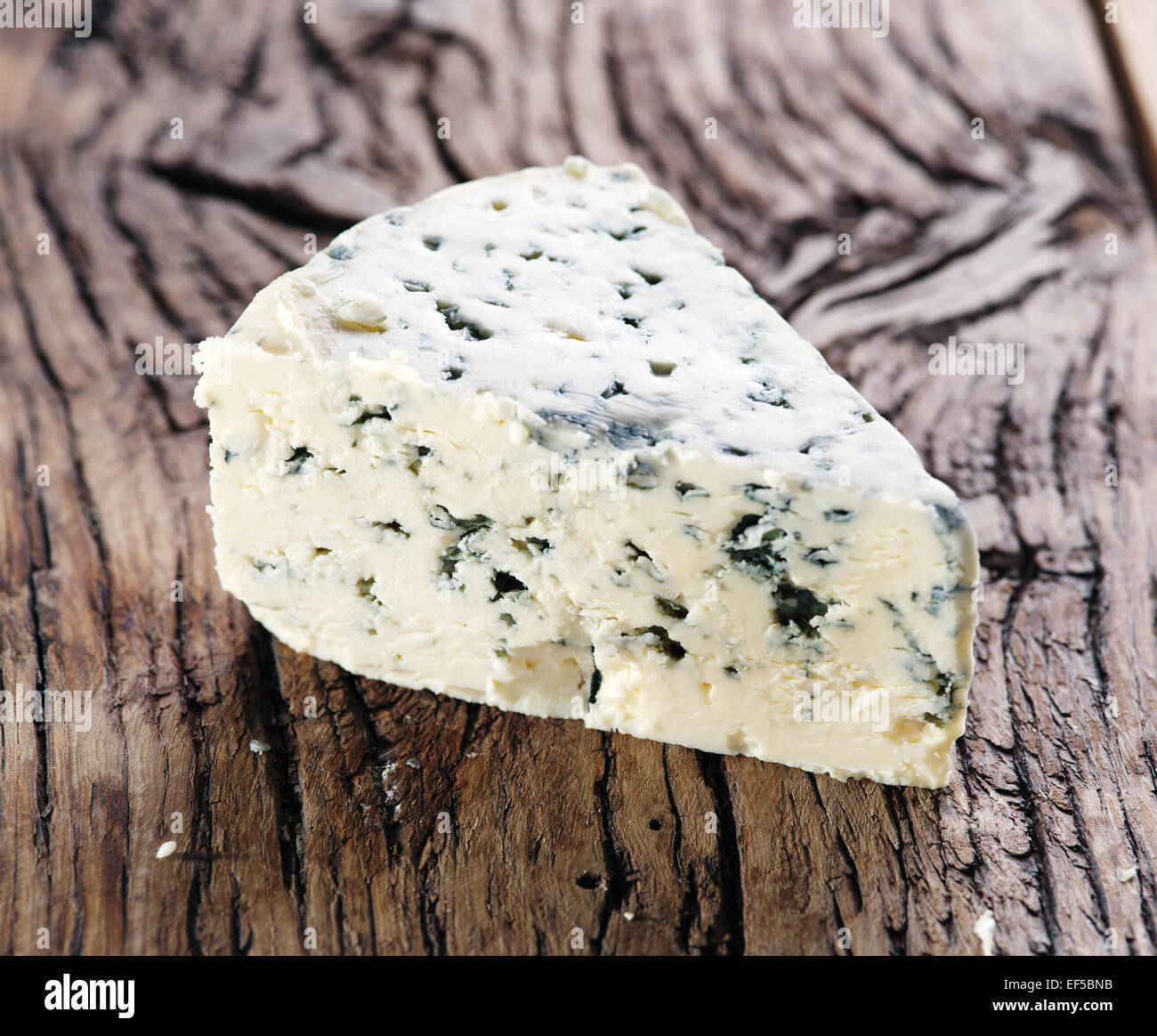 Slices of Danish Blue cheese on an old wooden table Stock Photo - Alamy
