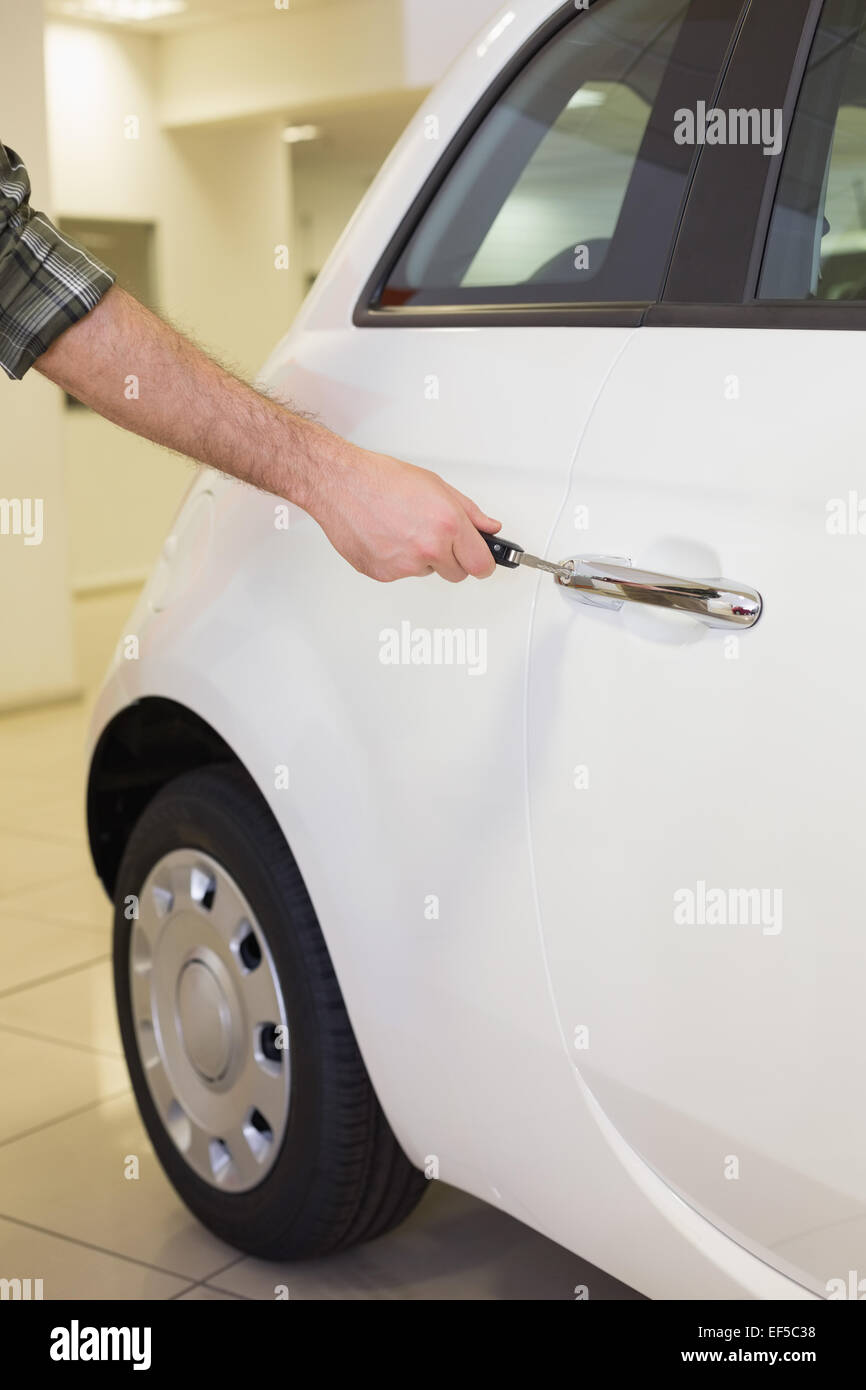 Man opening a car with a key Stock Photo - Alamy