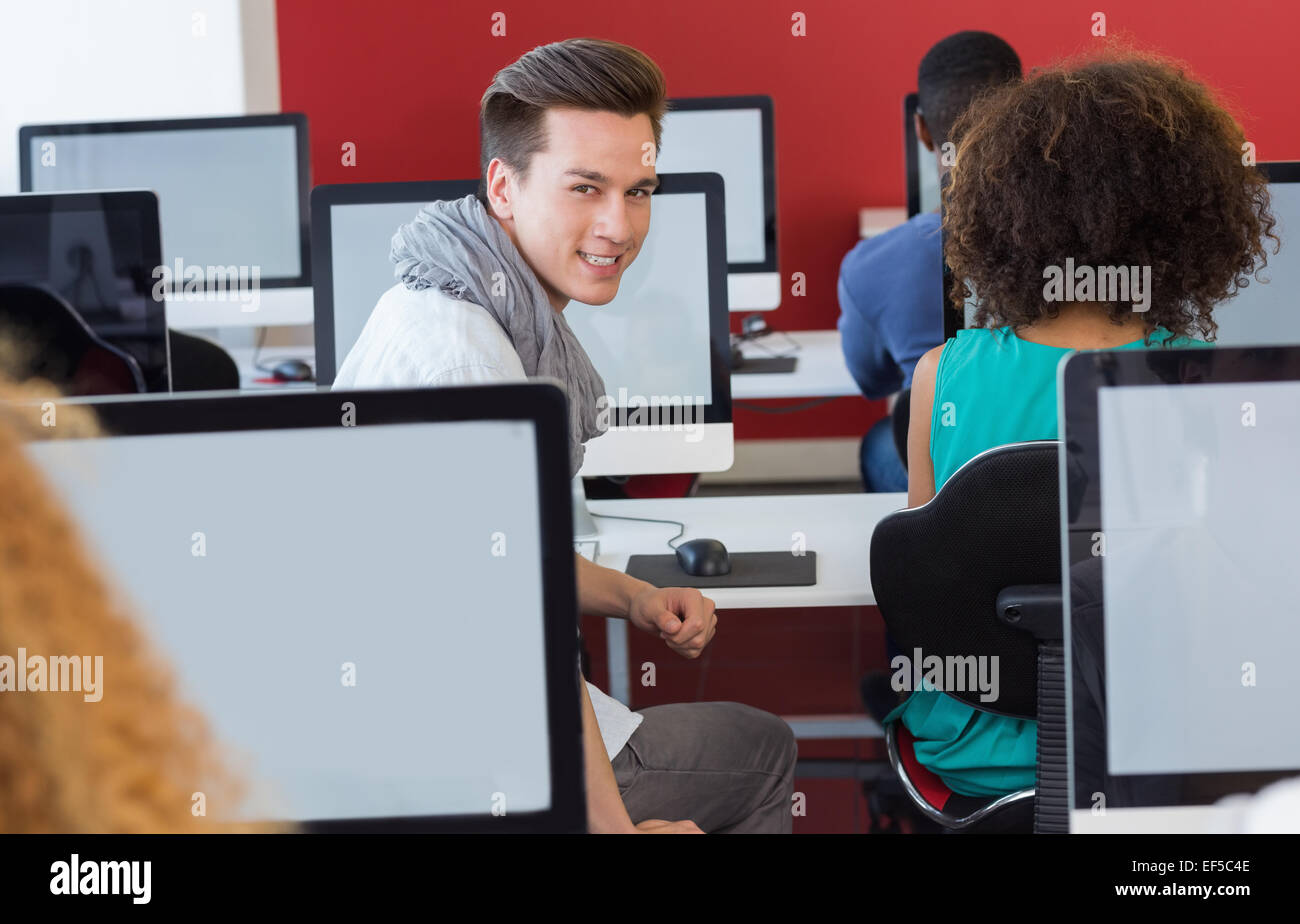 Student smiling at camera in computer class Stock Photo - Alamy
