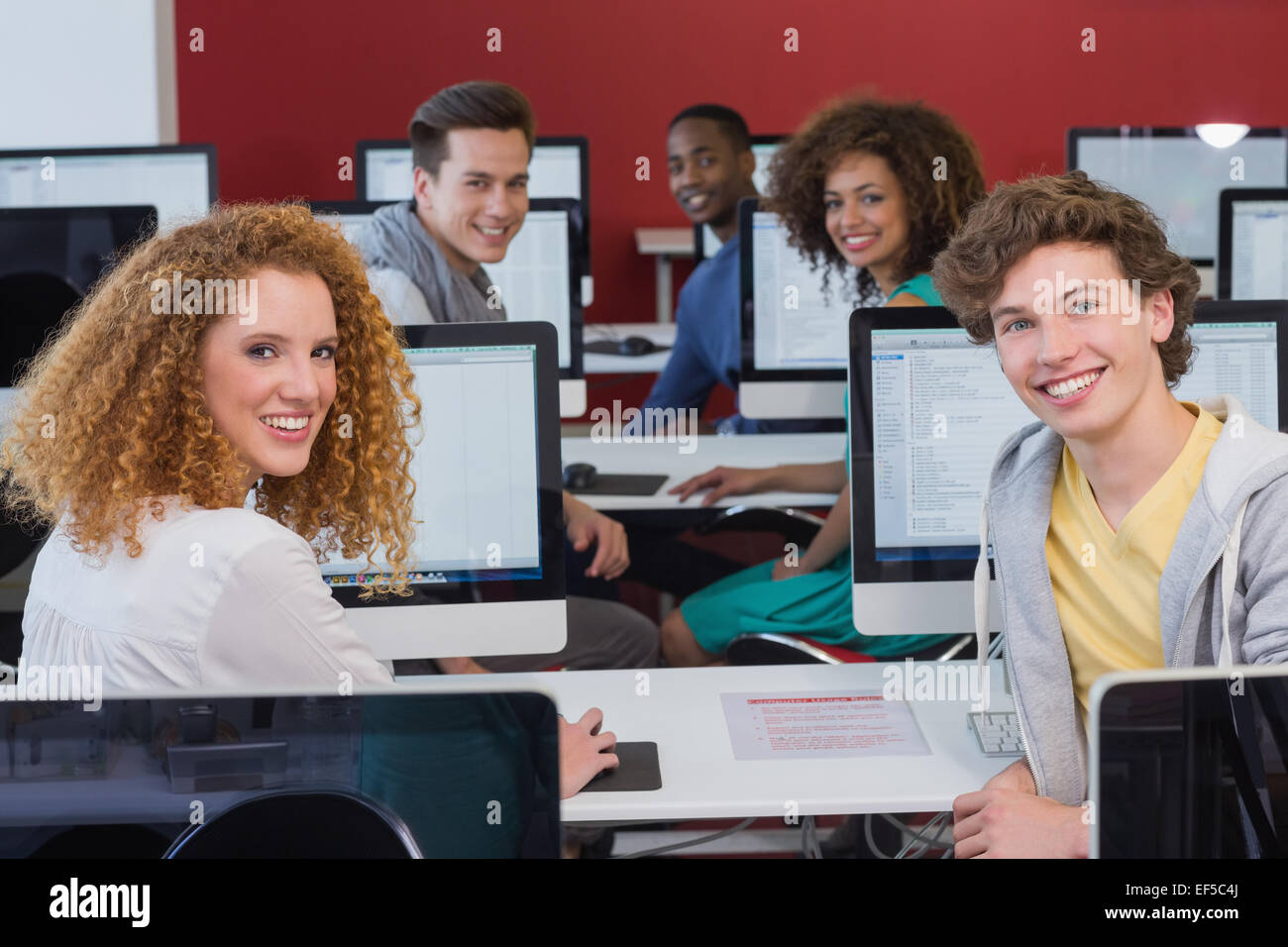 Students smiling at camera in computer class Stock Photo - Alamy