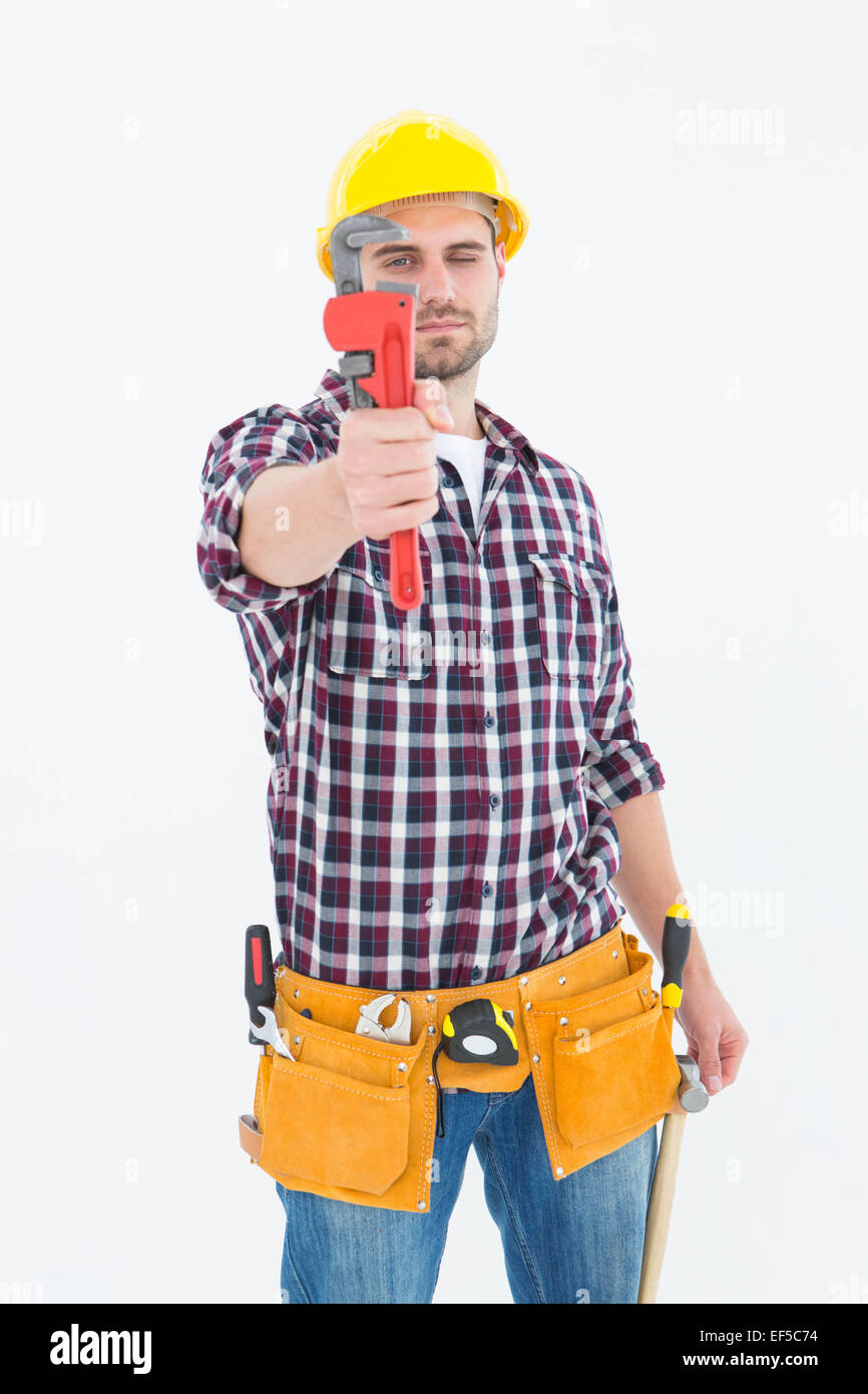 Handyman looking through adjustable wrench Stock Photo - Alamy