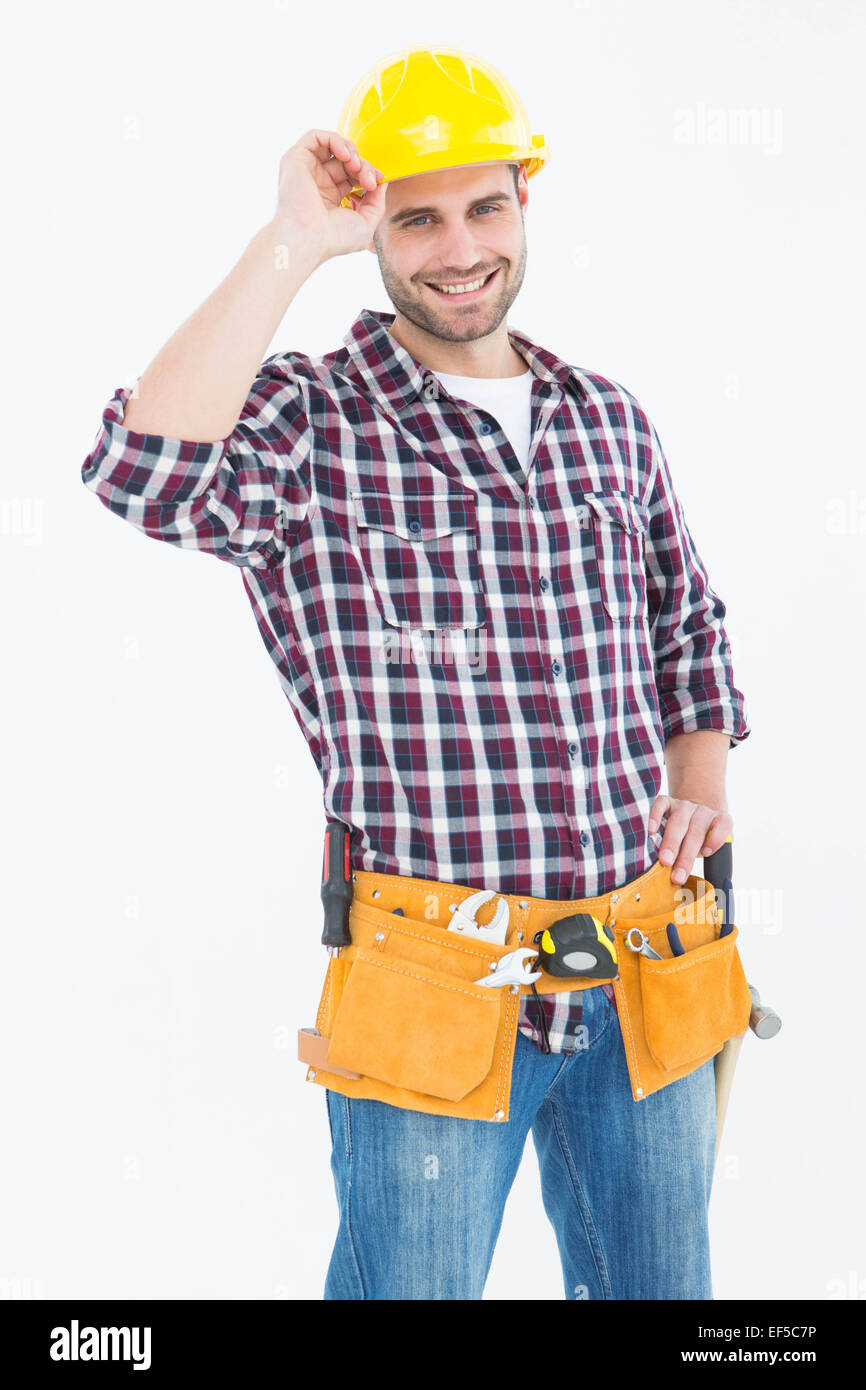 Confident handyman wearing hard hat Stock Photo - Alamy