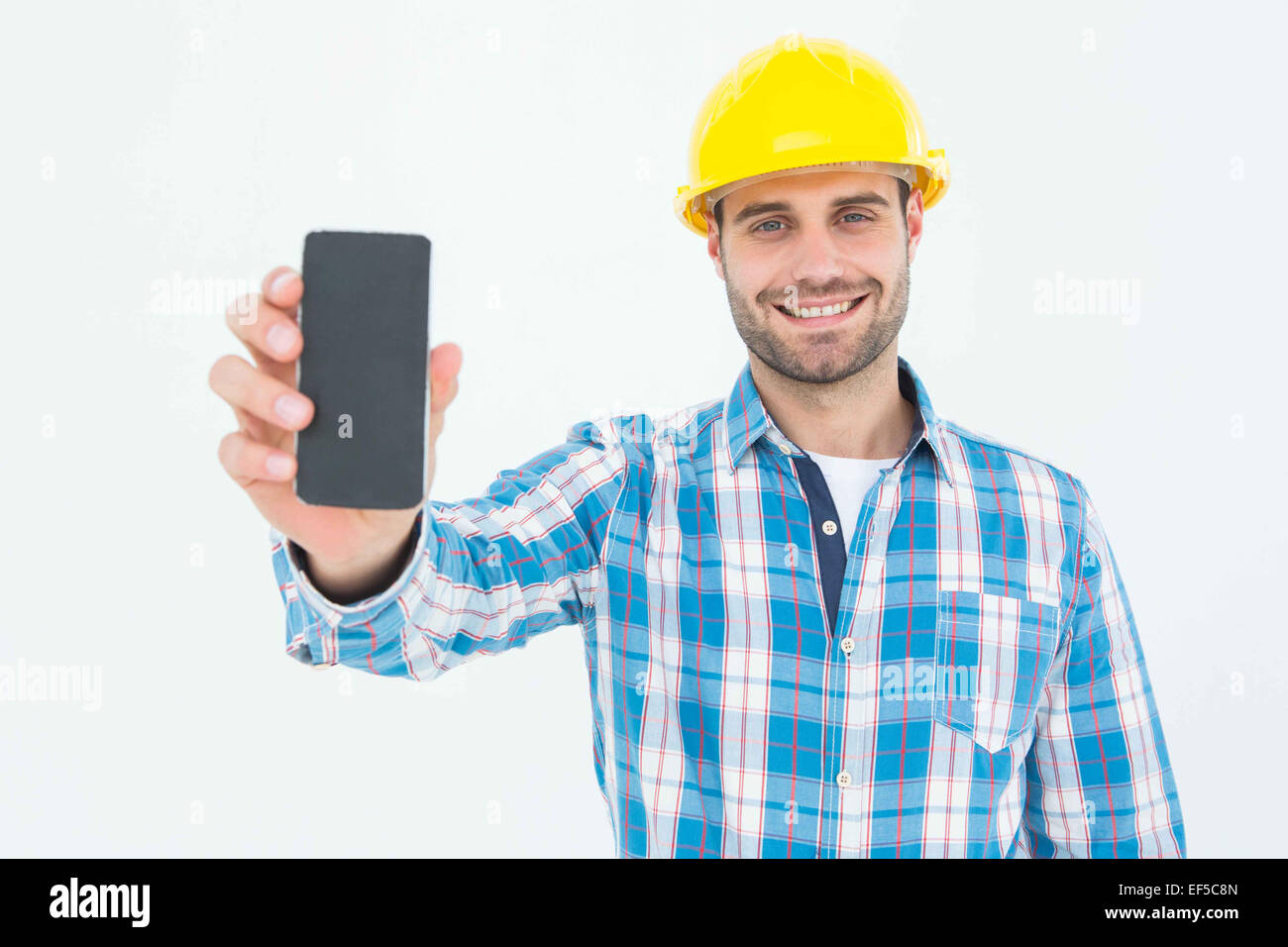 Happy construction worker showing smart phone Stock Photo - Alamy