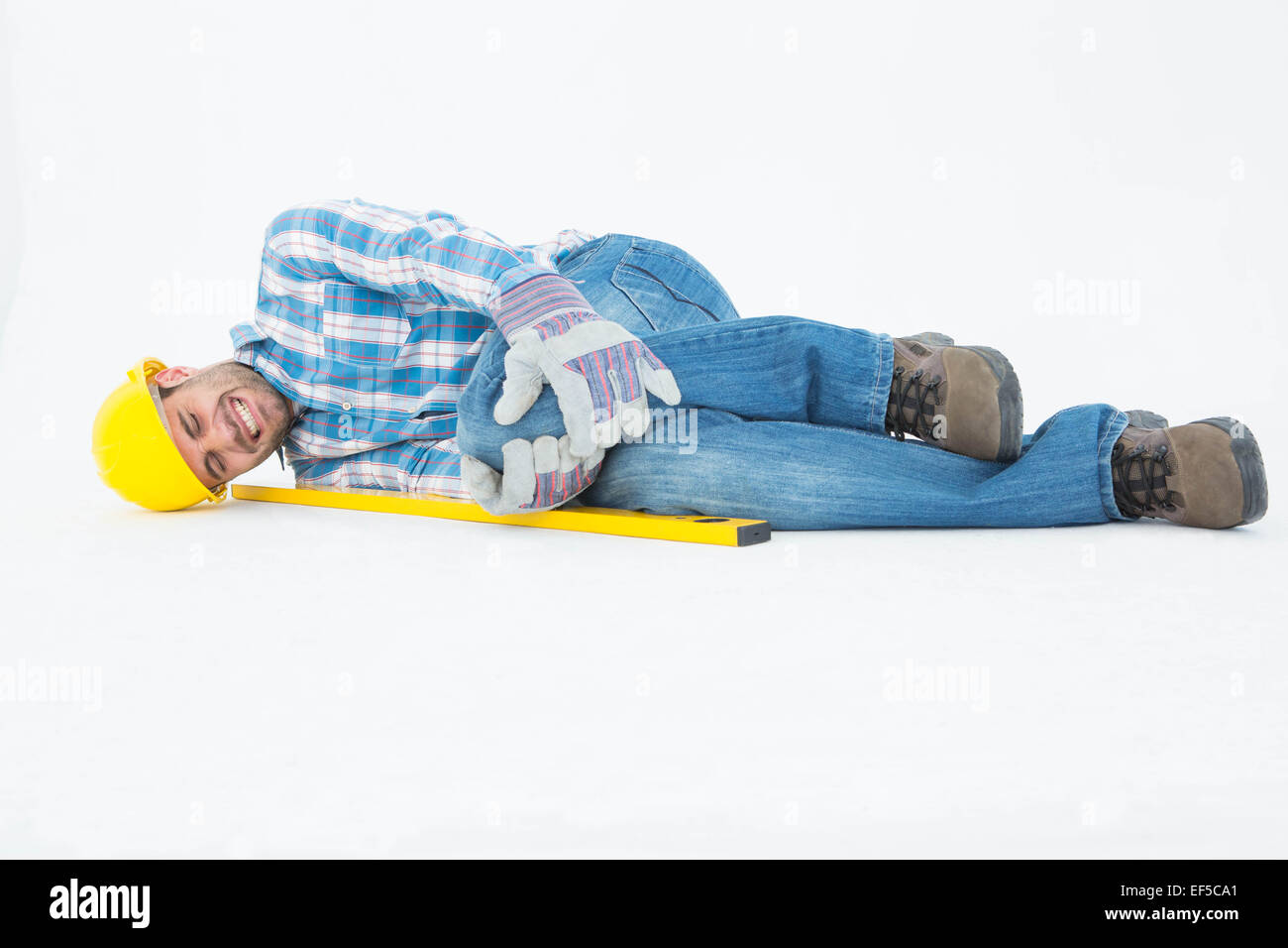 Construction worker suffering from knee pain Stock Photo - Alamy