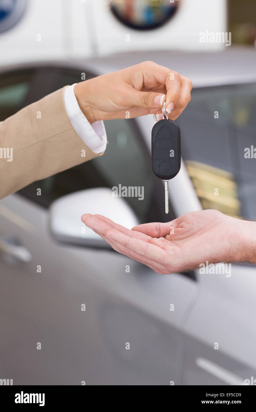 Businesswoman giving car key to happy customer Stock Photo - Alamy