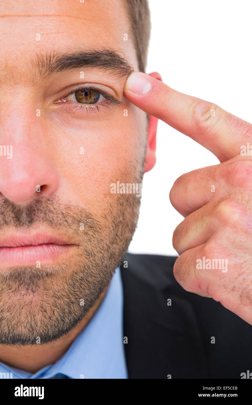 Businessman pointing his head with his finger Stock Photo - Alamy