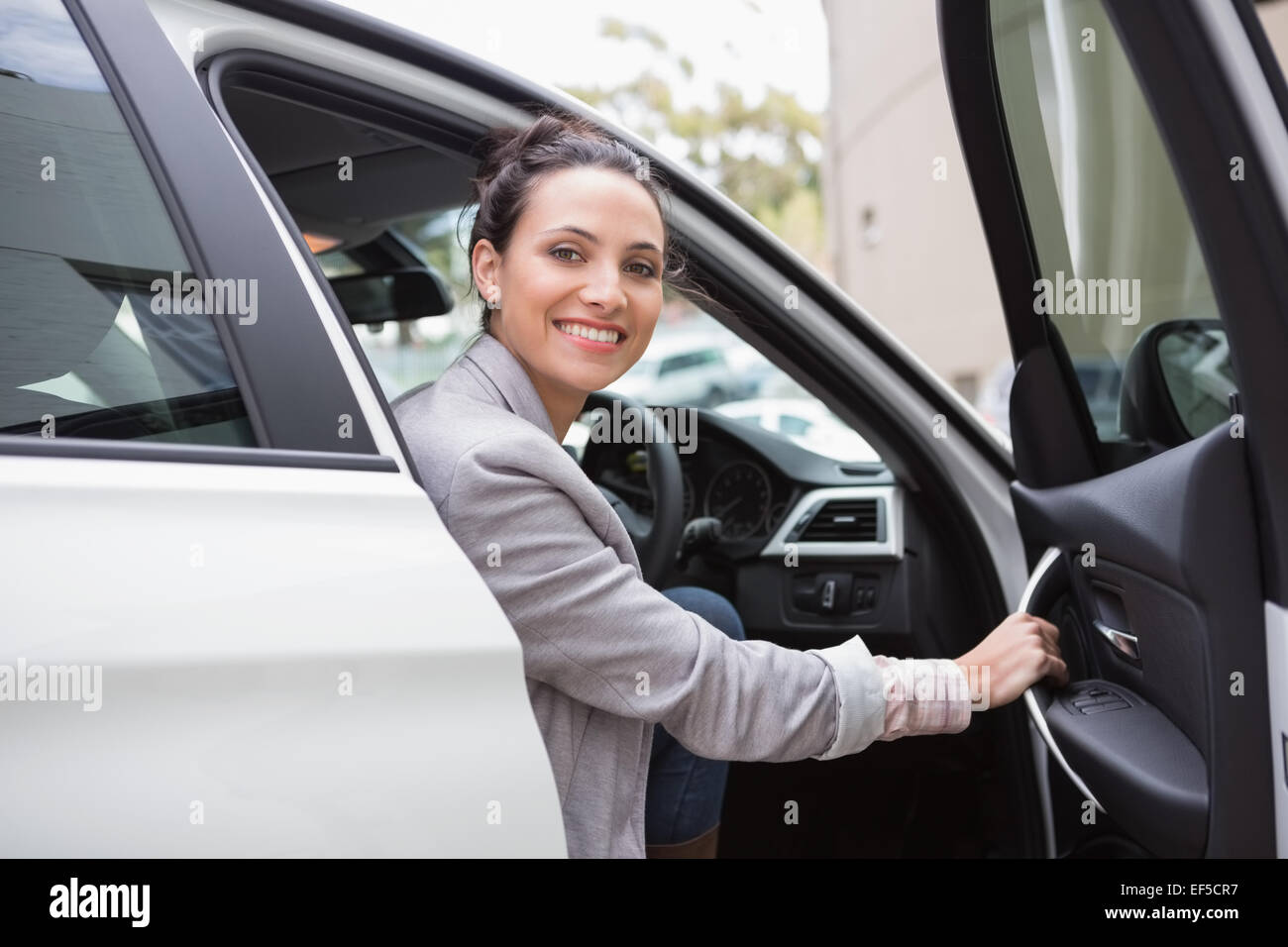 Businesswoman sitting in drivers seat Stock Photo - Alamy