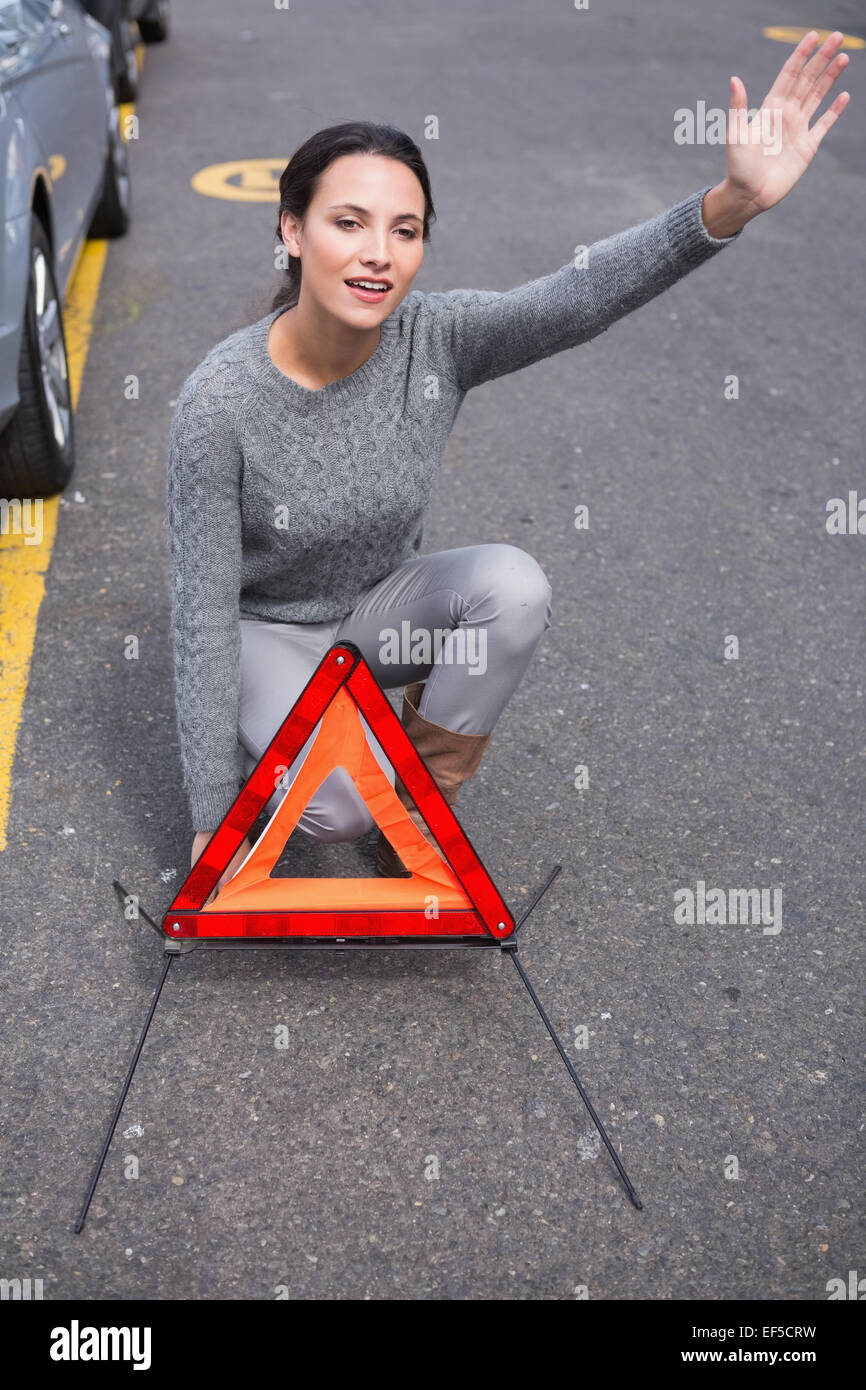 Smiling pretty woman hitch hiking Stock Photo - Alamy