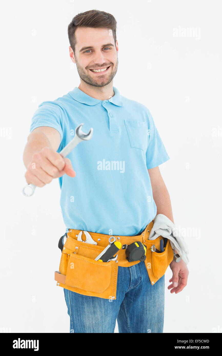Smiling construciton worker holding wrench Stock Photo - Alamy