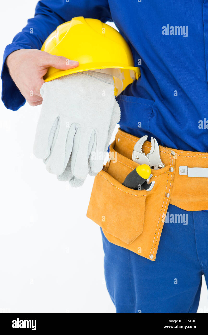 Cropped image of repairman holding helmet and gloves Stock Photo - Alamy