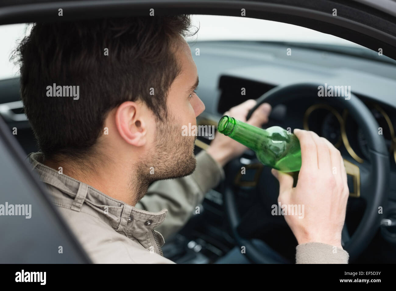 Man drinking beer while driving Stock Photo - Alamy