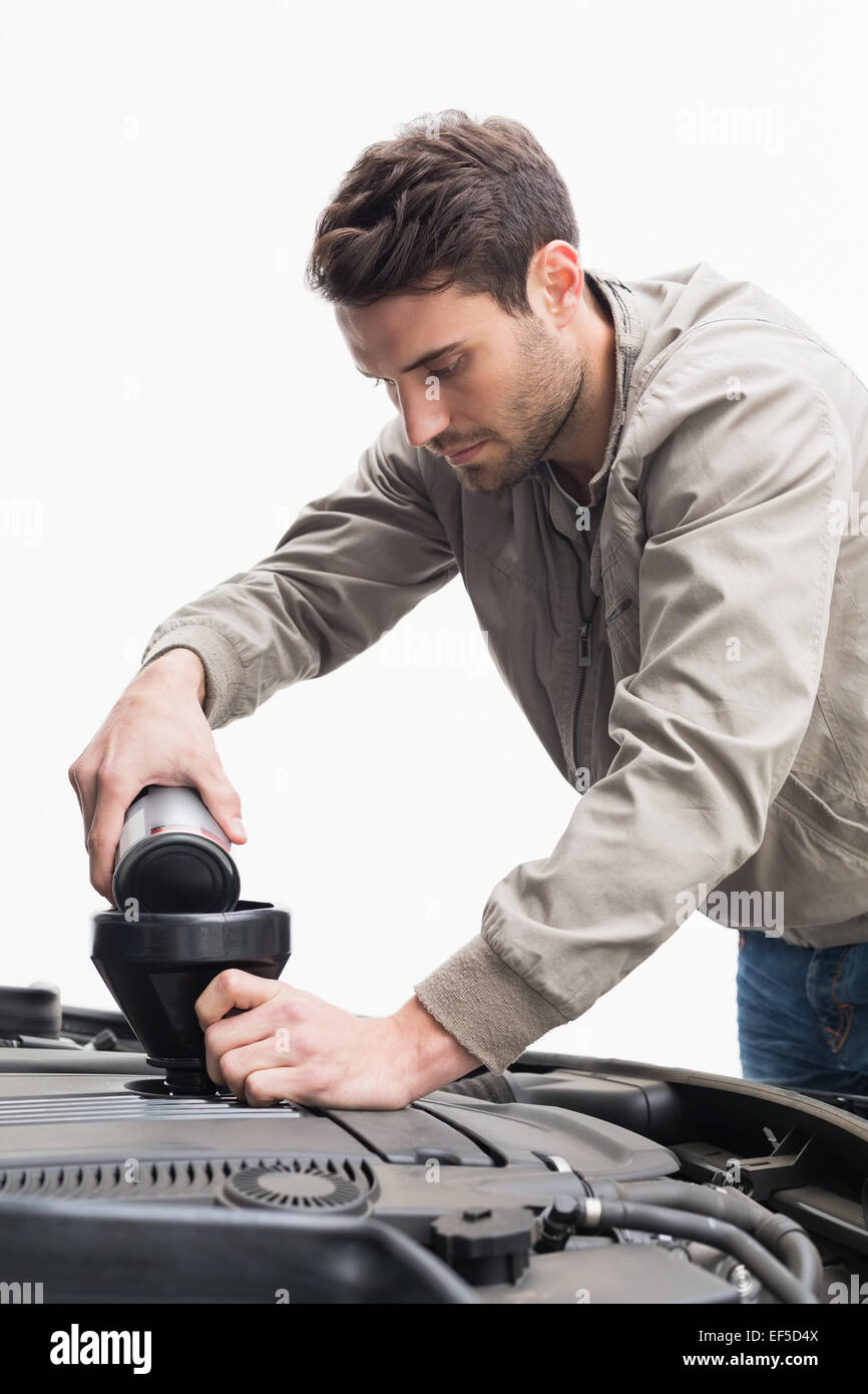 Man pouring oil into engine Stock Photo - Alamy