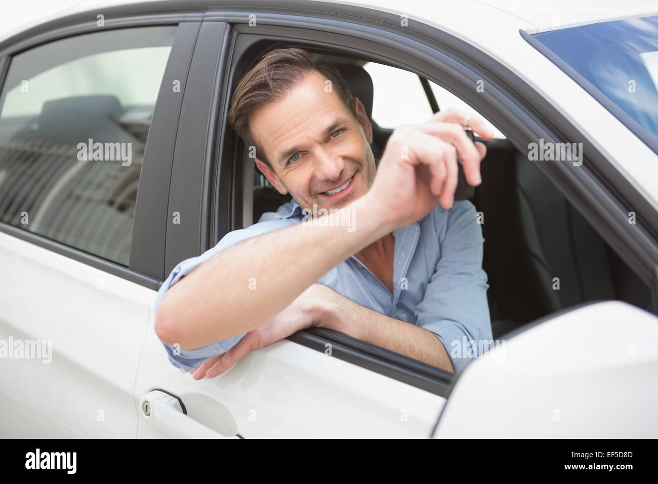 Handsome man smiling at camera Stock Photo - Alamy