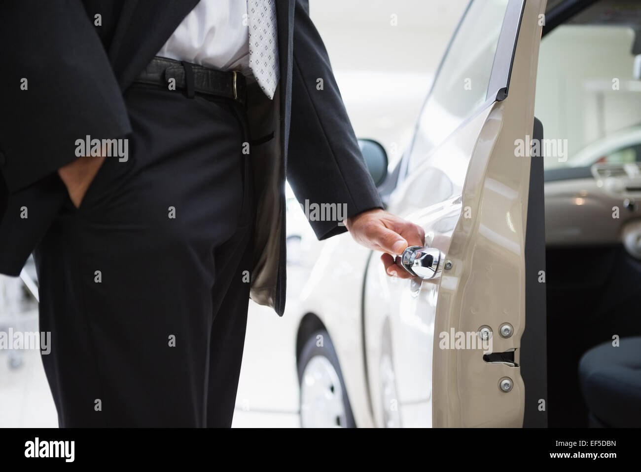 Man opening a car door Stock Photo - Alamy