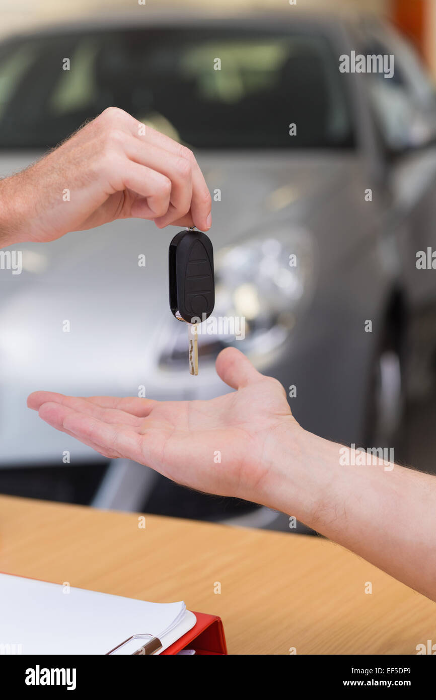 Salesman giving a customer car keys Stock Photo - Alamy