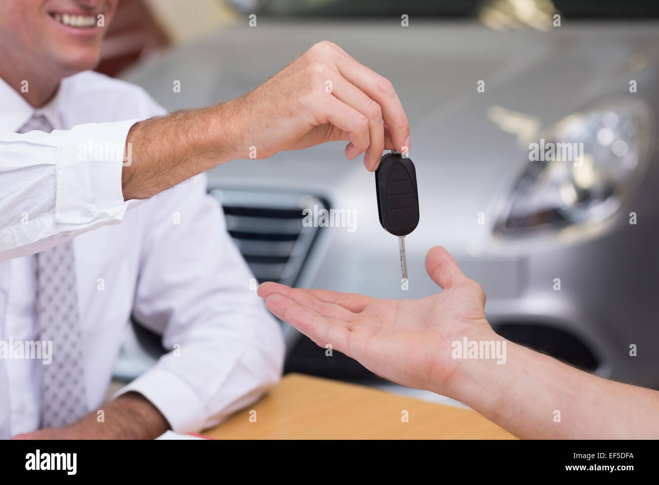 Salesman giving a customer car keys Stock Photo - Alamy