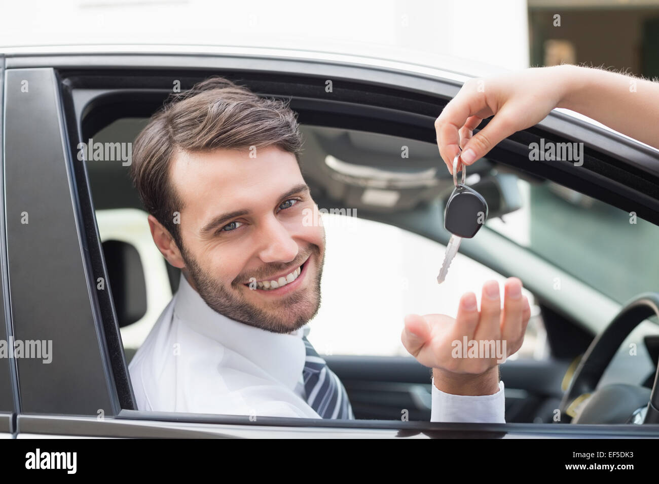 Businessman getting his new car key Stock Photo - Alamy
