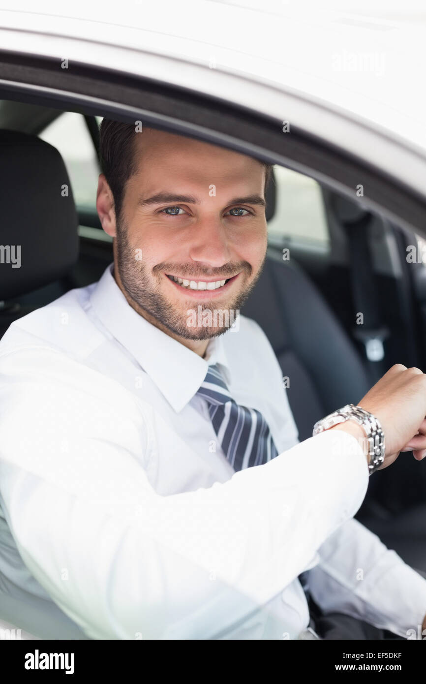 Businessman sitting checking watch smiling hi-res stock photography and ...