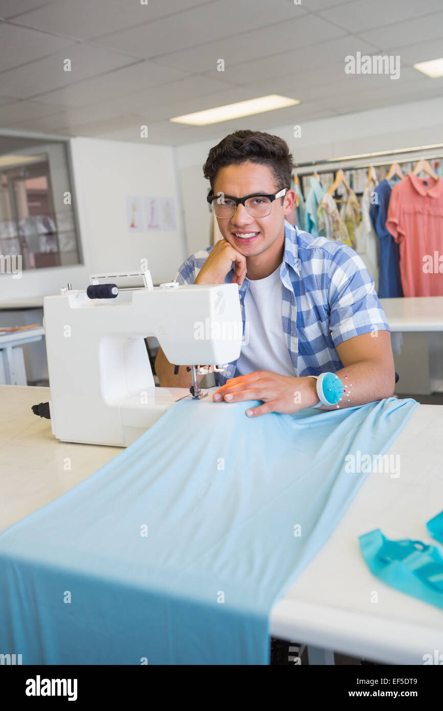 Smiling university student sewing Stock Photo - Alamy