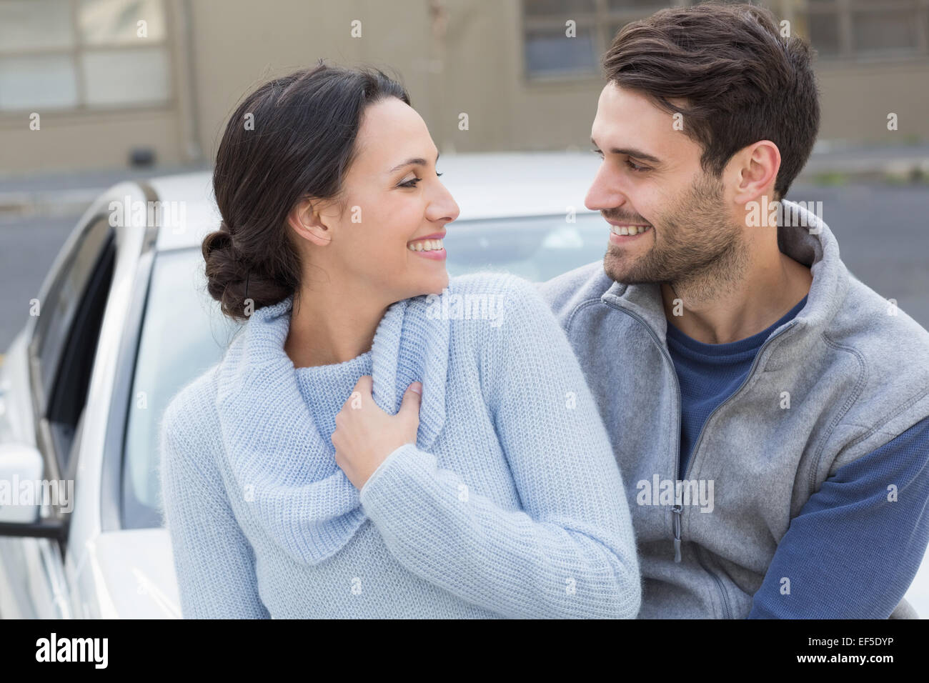 Young couple smiling at each other Stock Photo - Alamy