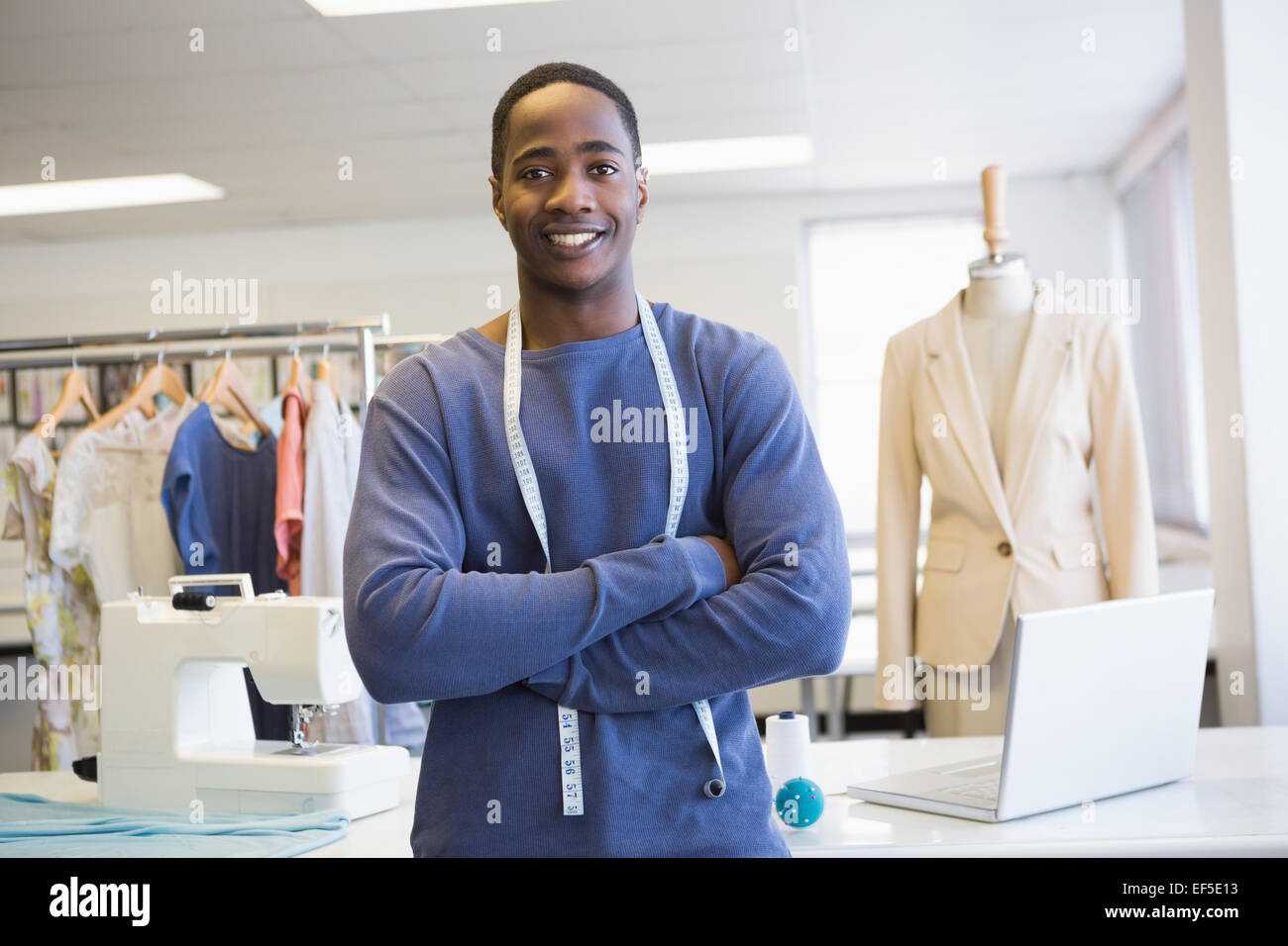 Smiling university student posing with arms crossed Stock Photo - Alamy